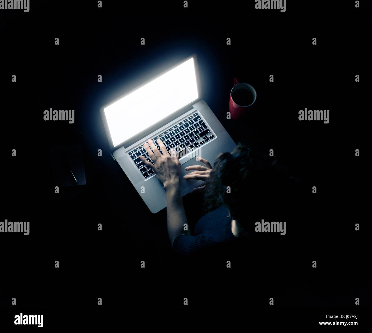 Woman lit by laptop screen hi-res stock photography and images - Alamy