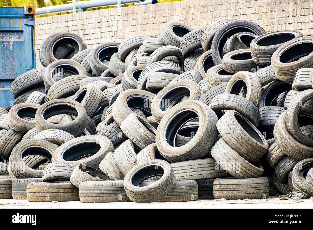 large heap of old used car tyres ready for recycling Stock Photo - Alamy