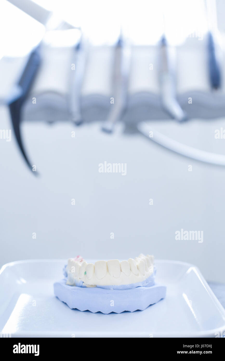 Denture model on a tray with specialist dental tools, drills ...