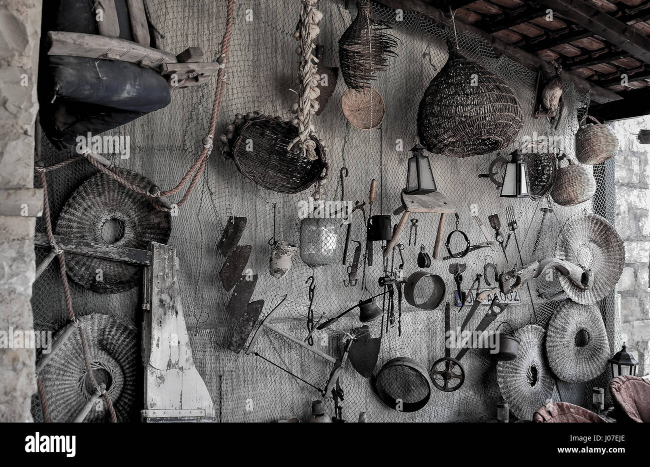 Ancient tools hanging on fishing net Stock Photo - Alamy