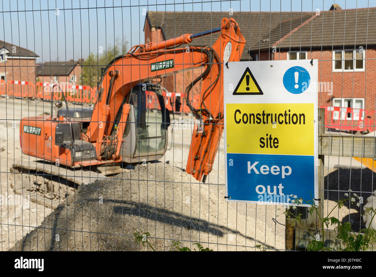 Signage on a perimeter fence surrounding a construction site in the UK ...