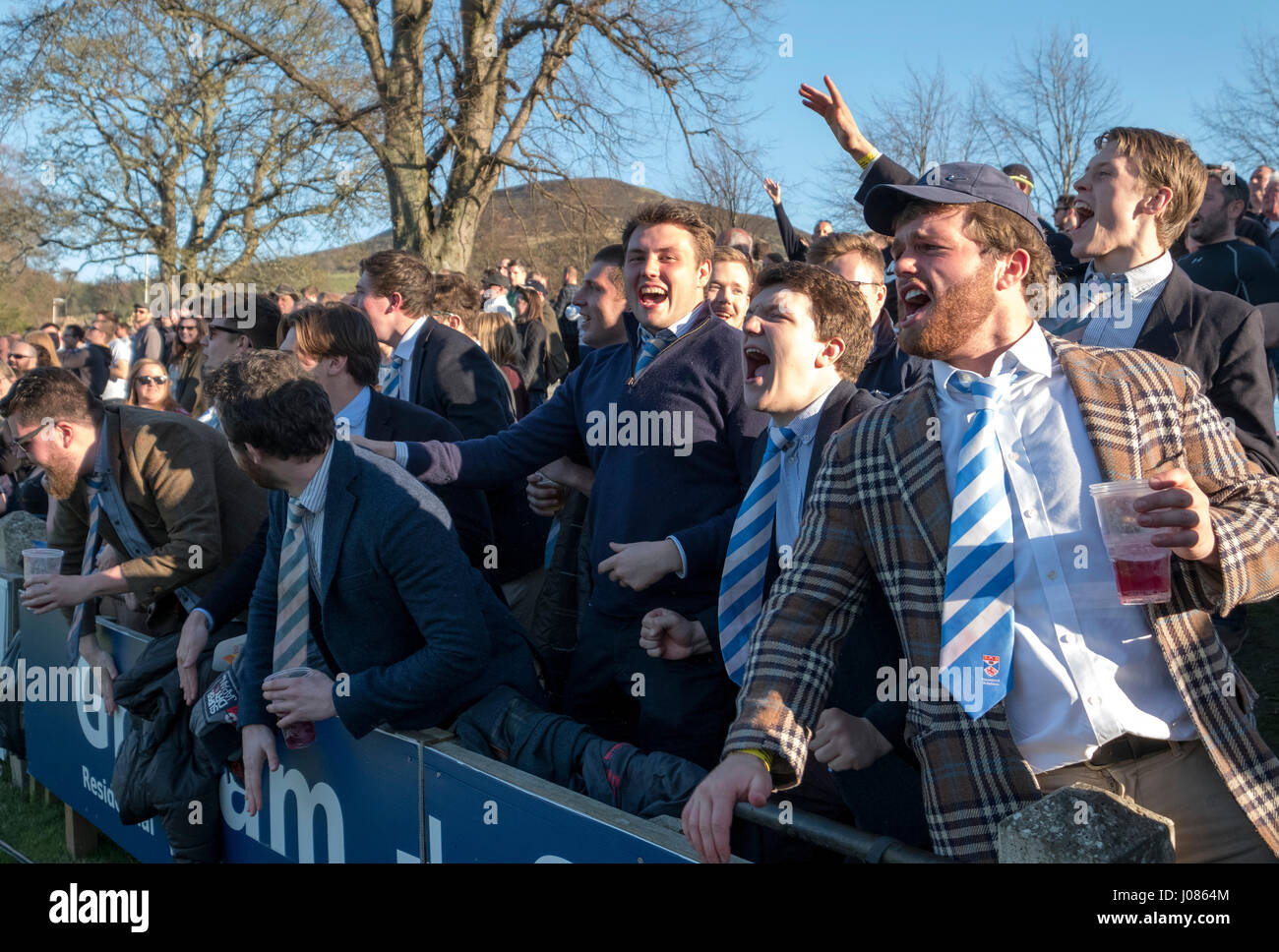 Rugby fans drinking beer cheer their team on during the Melrose sevens ...