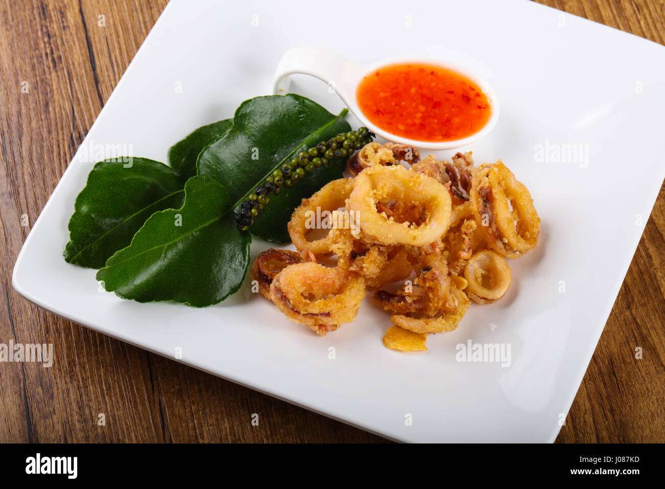 Fried squid rings with hot spicy sauce Stock Photo - Alamy