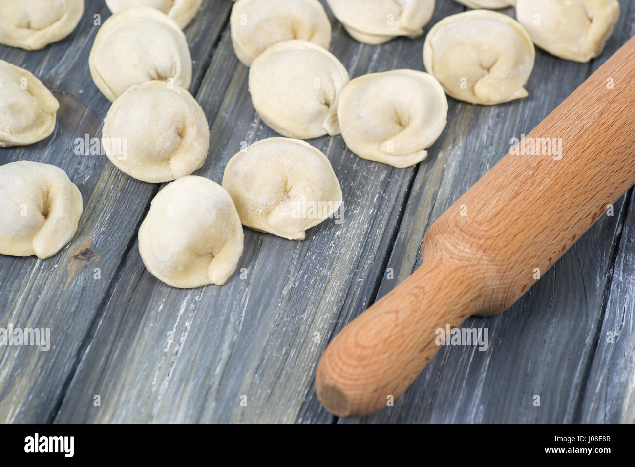 cooking dumplings molding with his hands on wooden background Stock ...