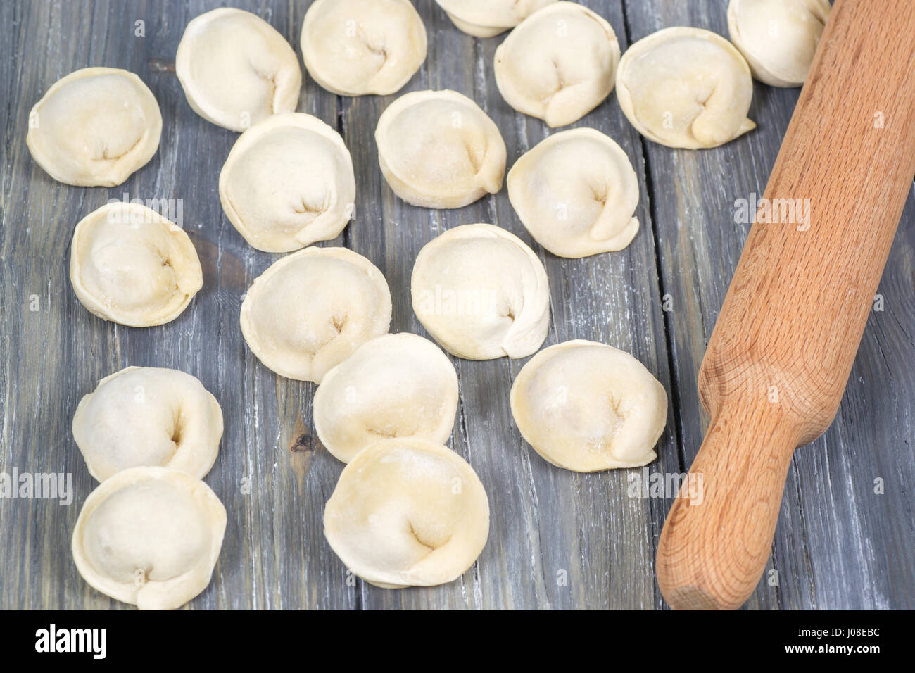 cooking dumplings molding with his hands on wooden background Stock ...