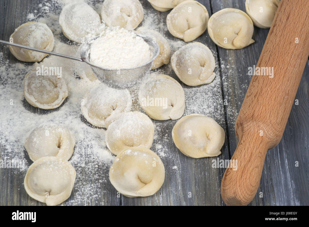 cooking dumplings molding with his hands on wooden background Stock ...