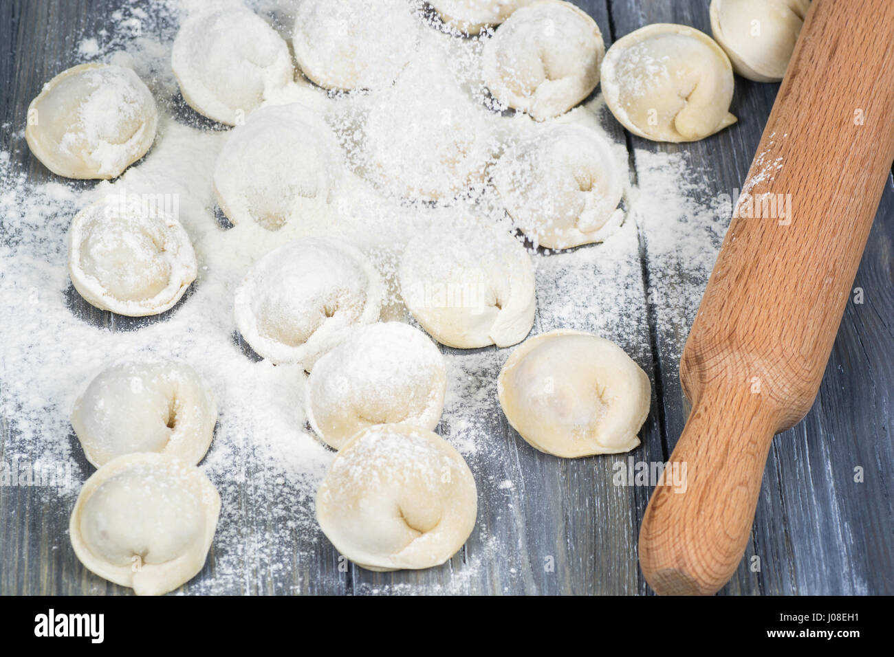 cooking dumplings molding with his hands on wooden background Stock ...