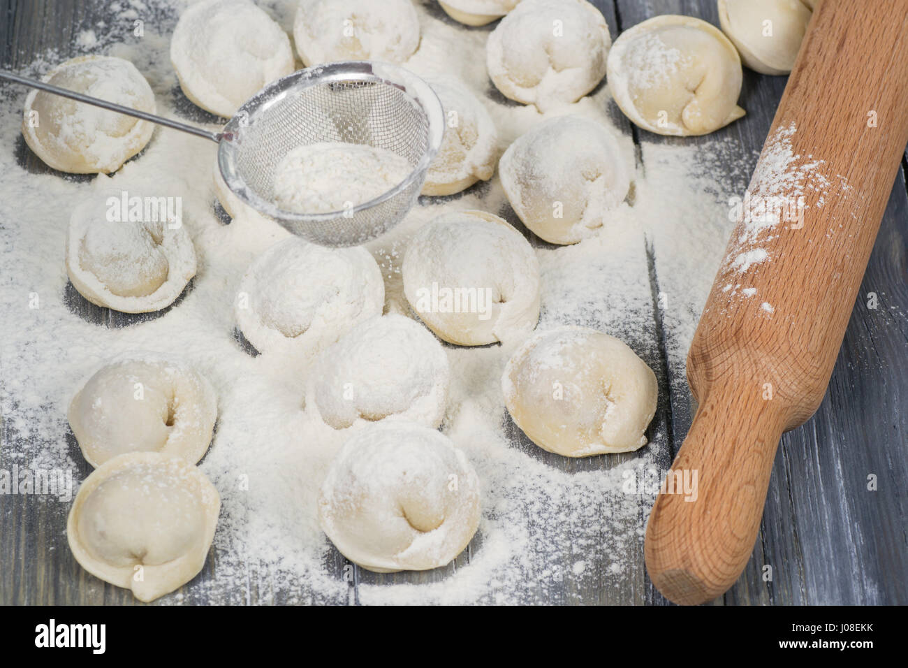 cooking dumplings molding with his hands on wooden background Stock ...