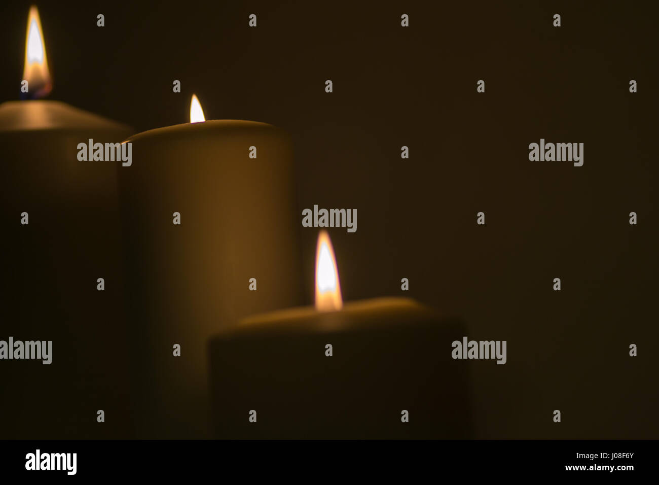 a candle is lit in the darkness and gives spiritual warmth Stock Photo ...