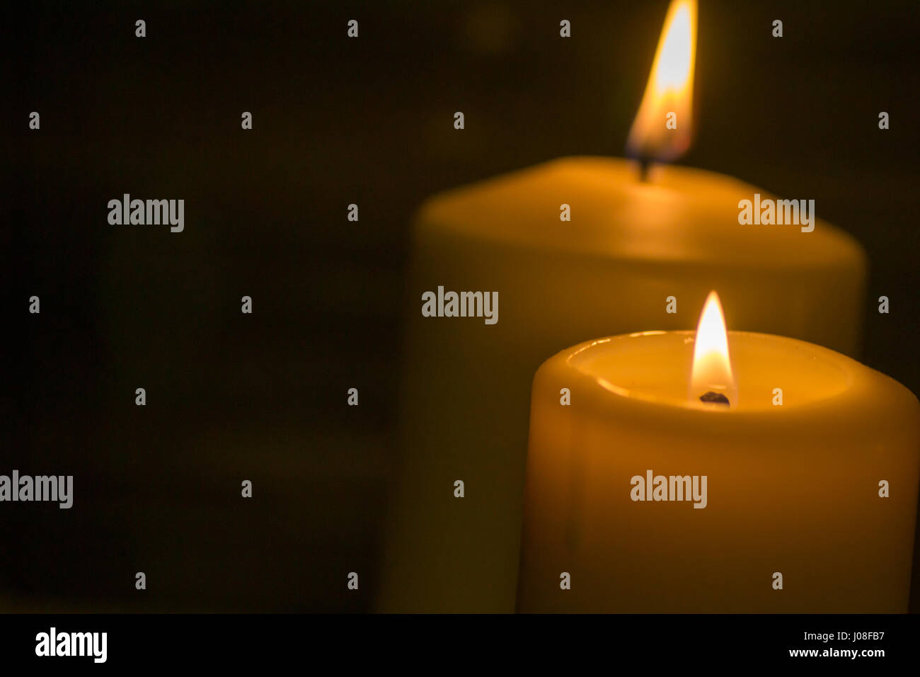 a candle is lit in the darkness and gives spiritual warmth Stock Photo ...