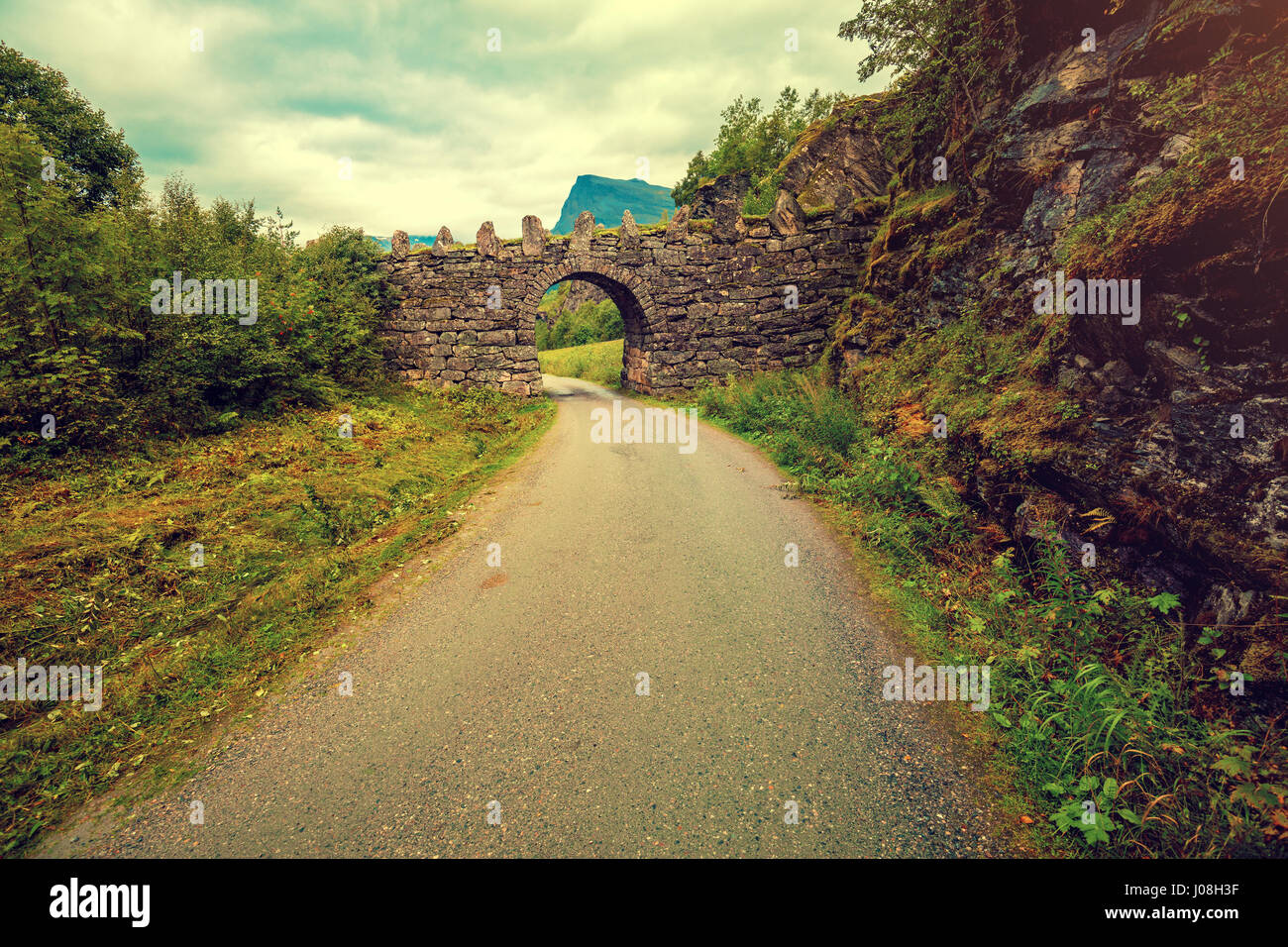 Stone arch over the road. Beautiful nature Stock Photo - Alamy