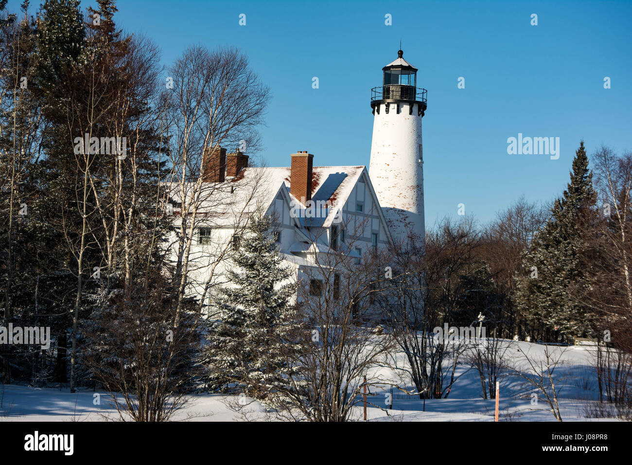winter lighthouse with pine trees and snow Stock Photo - Alamy
