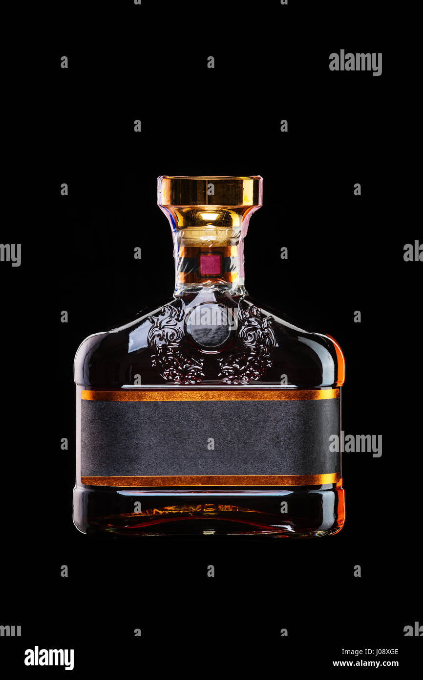Bottle of brandy with blank label over black background Stock Photo - Alamy