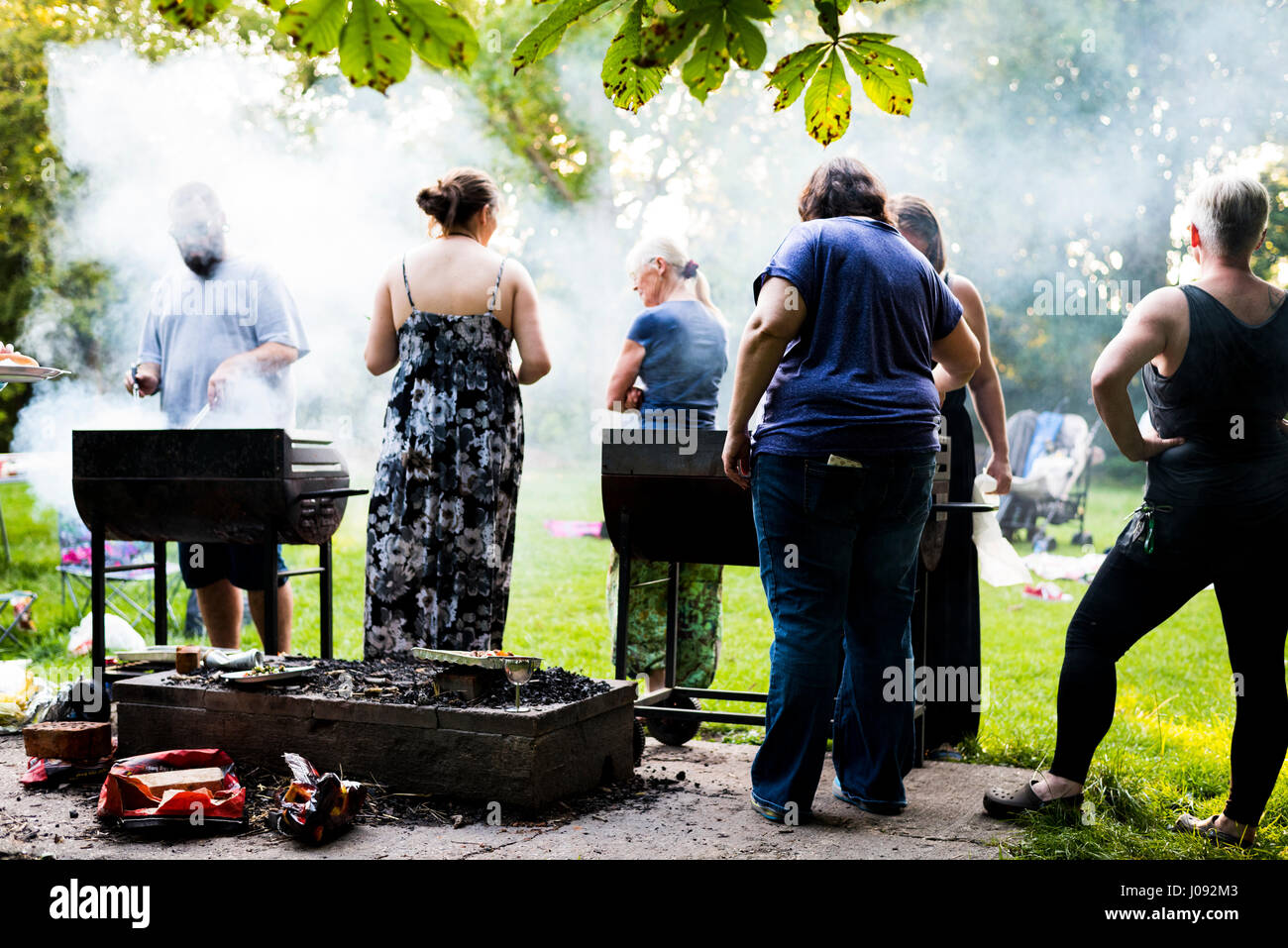 Friends having a barbecue on a campsite in the summer Stock Photo - Alamy