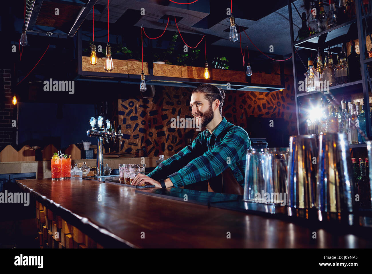 The bartender smiles at workplace in bar Stock Photo - Alamy