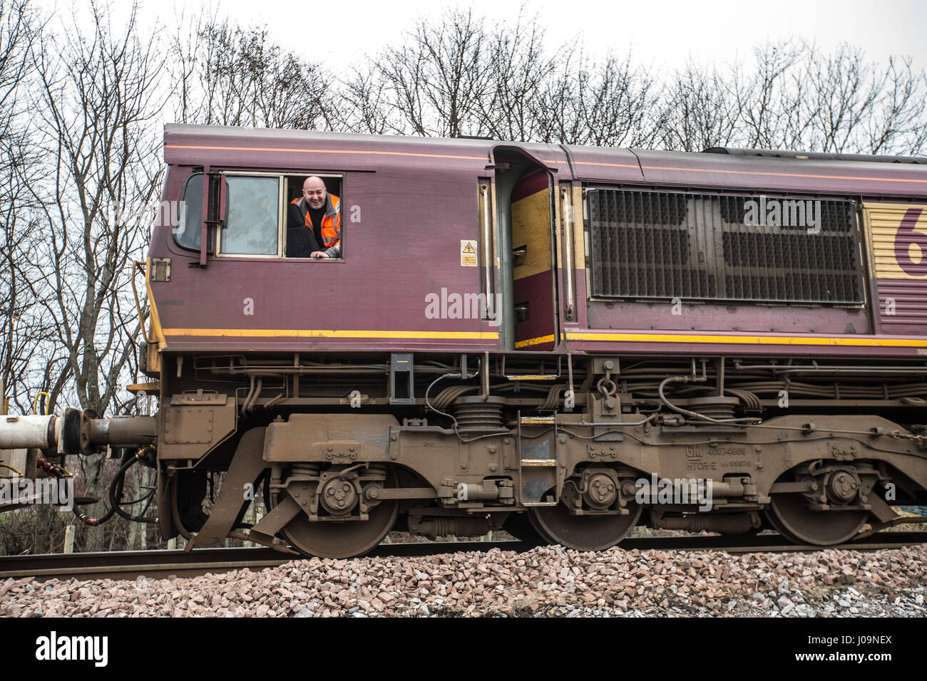Driver of ballast train leaning out of window Stock Photo - Alamy