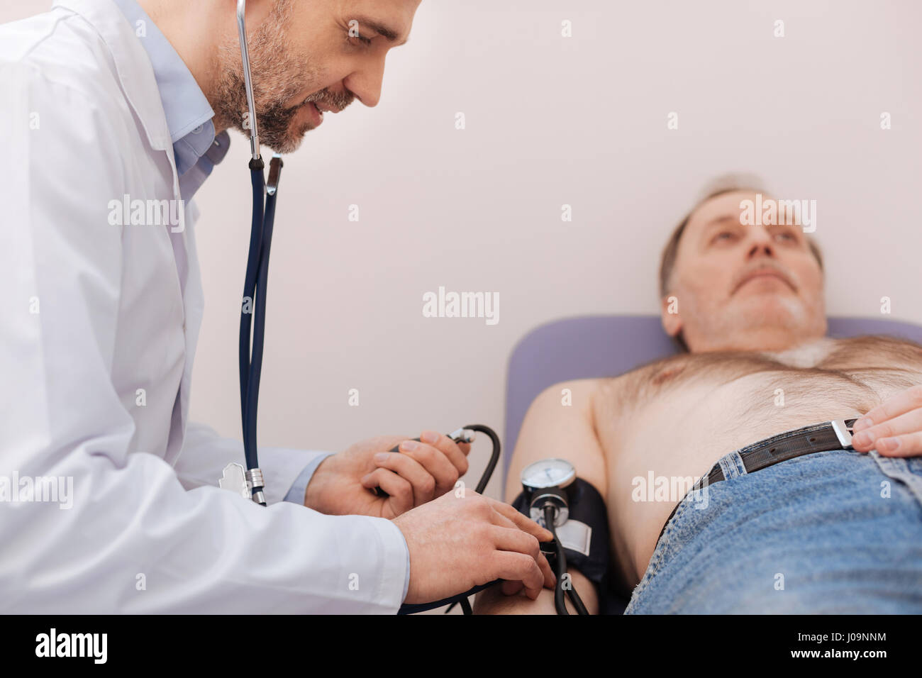 Doctor conducting examination patient hi-res stock photography and ...
