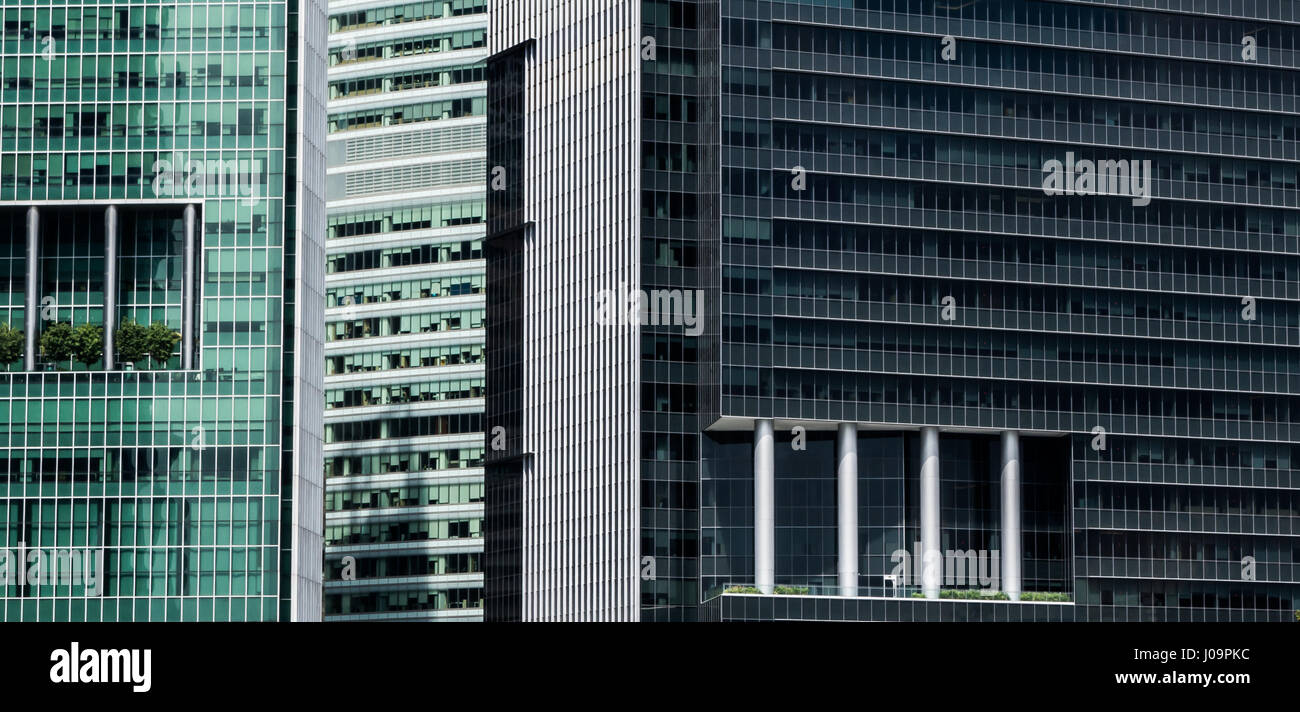 Three overlapping skyscaper facades in different shades with balconies ...