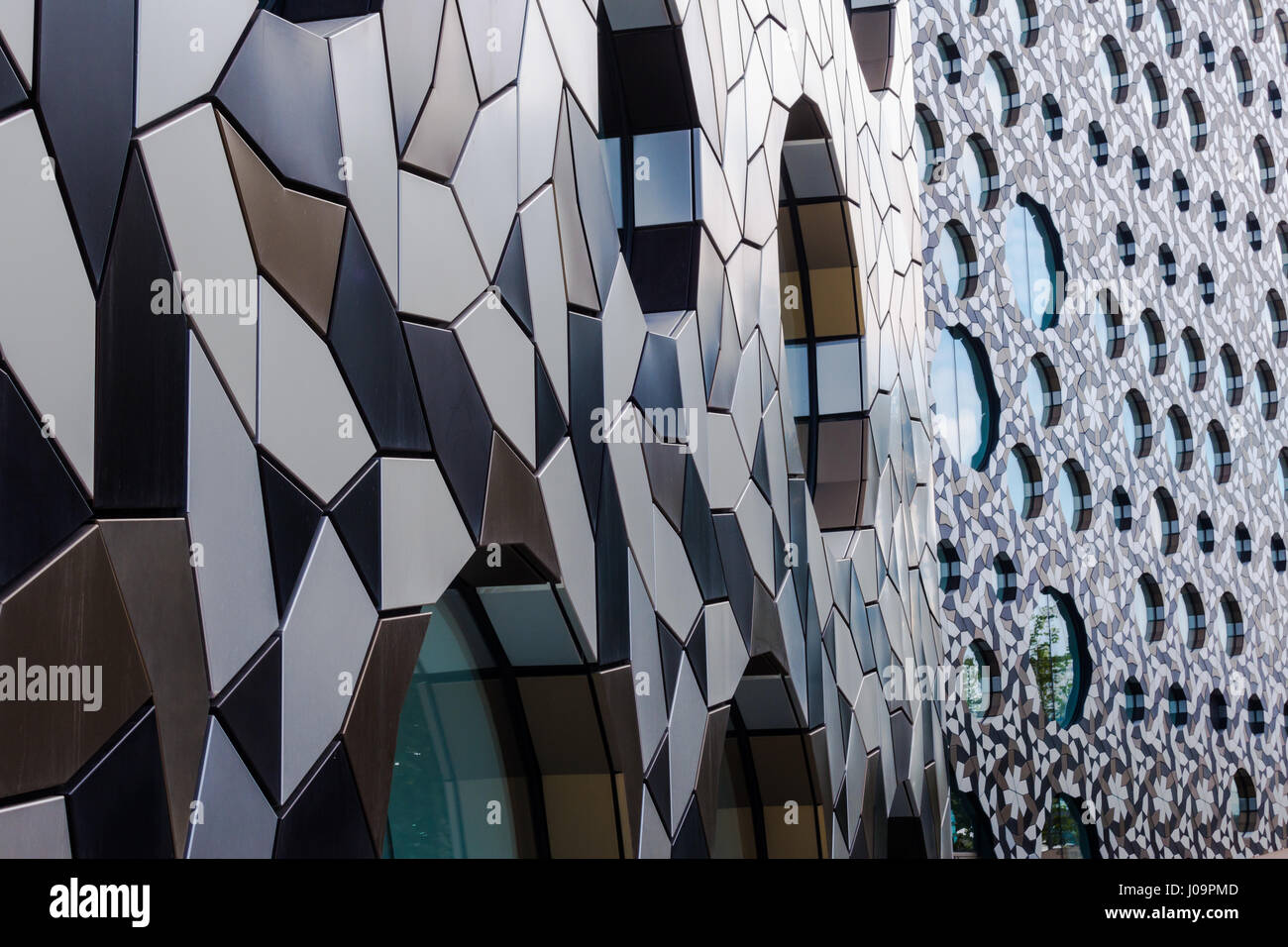 Facade of modern apartment building with circular shaped windows and ...
