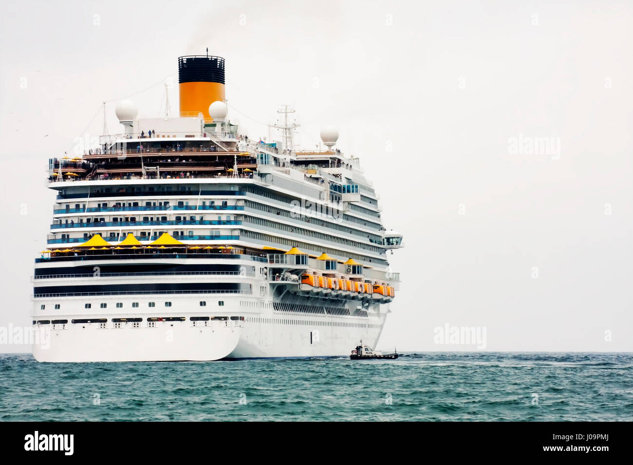 Cruise ship with pilot boat Stock Photo - Alamy