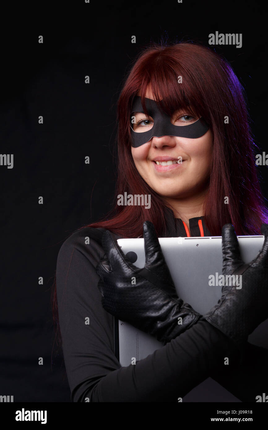 Laughing hacker in black gloves Stock Photo - Alamy