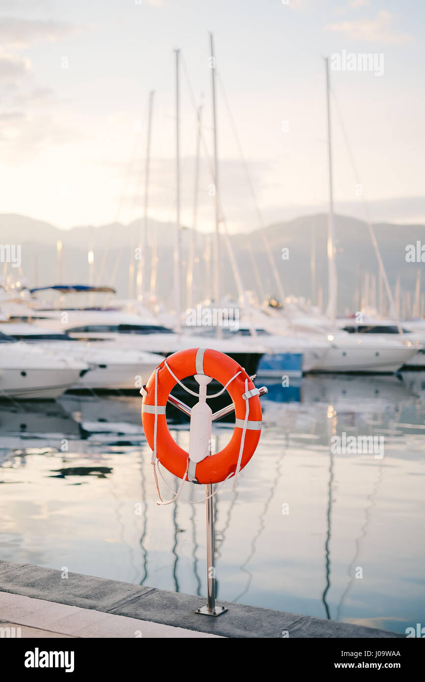 Lifebuoy in the marina for yachts. Red circle on the boat dock Stock ...