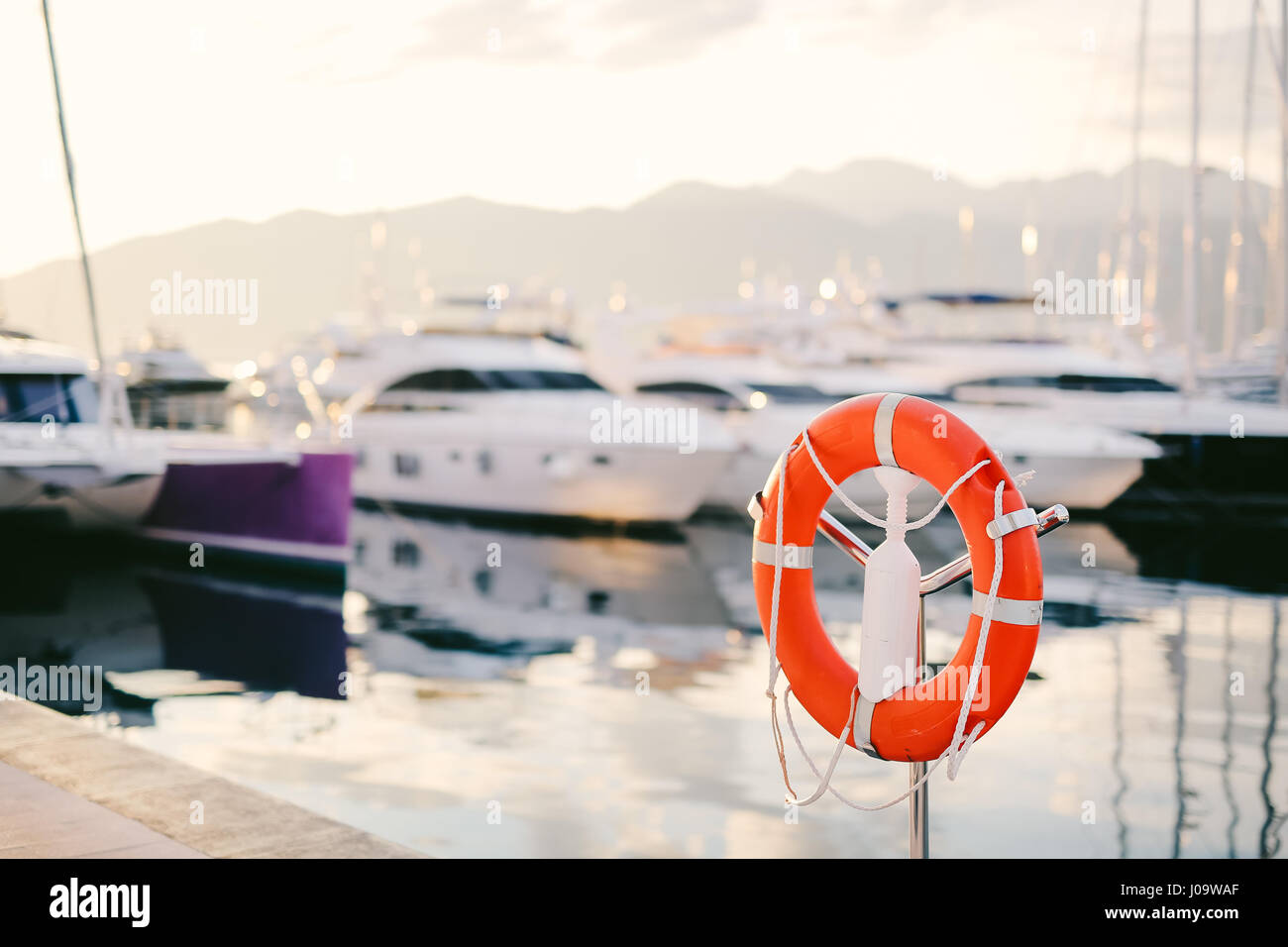 Lifebuoy in the marina for yachts. Red circle on the boat dock Stock ...
