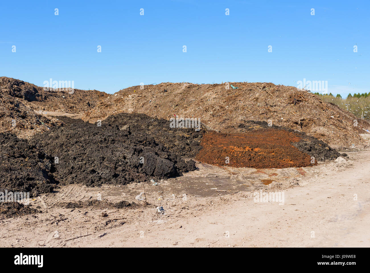 Piles of soil deposits at landfill over old dump Stock Photo - Alamy
