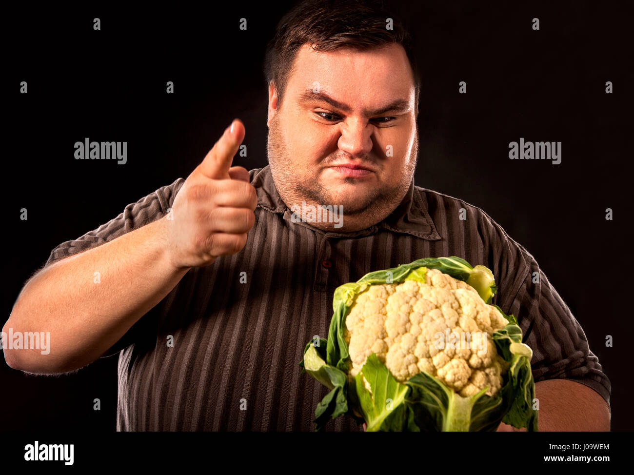 Diet fat man eating healthy food . Healthy breakfast with vegetables ...