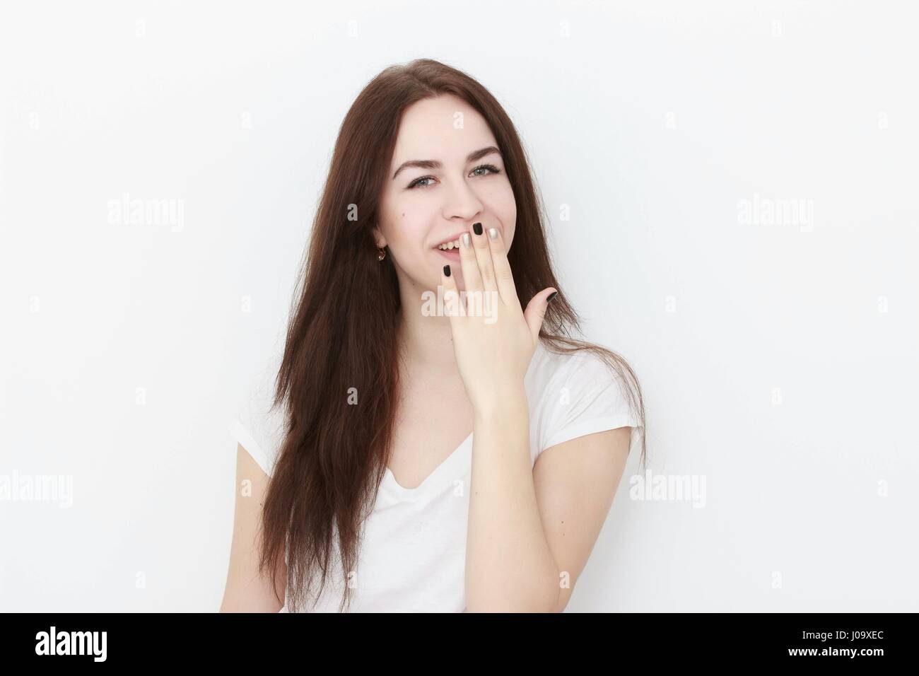 Young casual woman In pink blouse isolated over white background studio ...