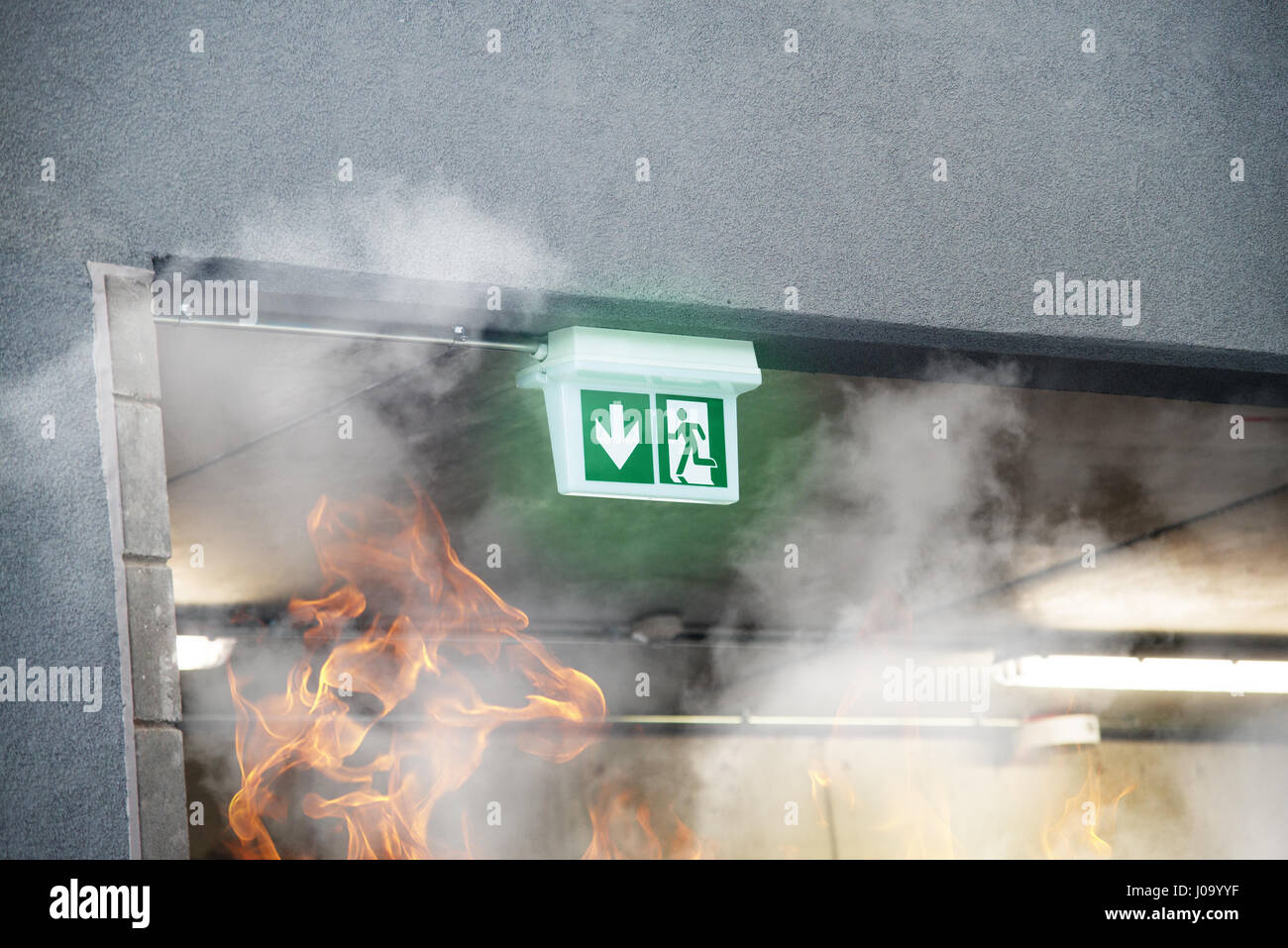 Emergency Fire Exit with smoke and fire flames Stock Photo - Alamy