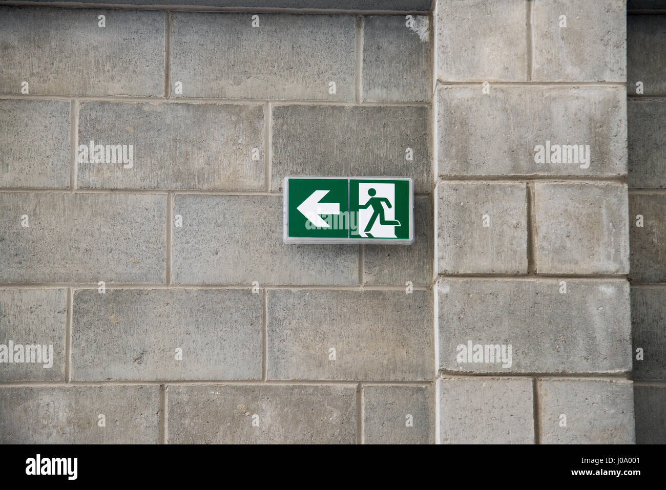 Emergency Fire Exit on the stone wall Stock Photo - Alamy
