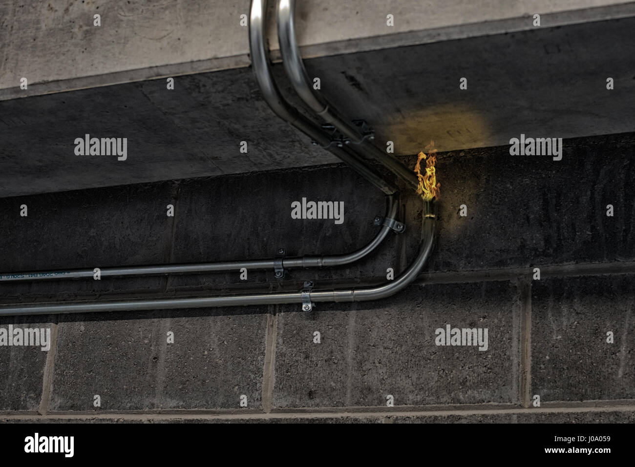 Burning electric wire on the stone wall Stock Photo - Alamy