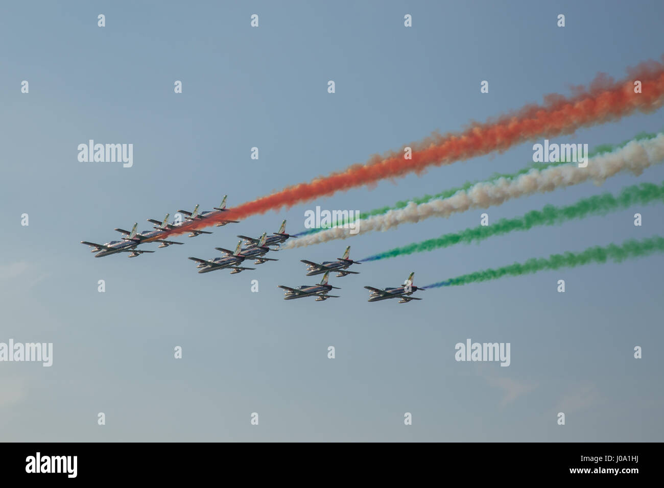 Air show with colored smoke green white and red Stock Photo - Alamy