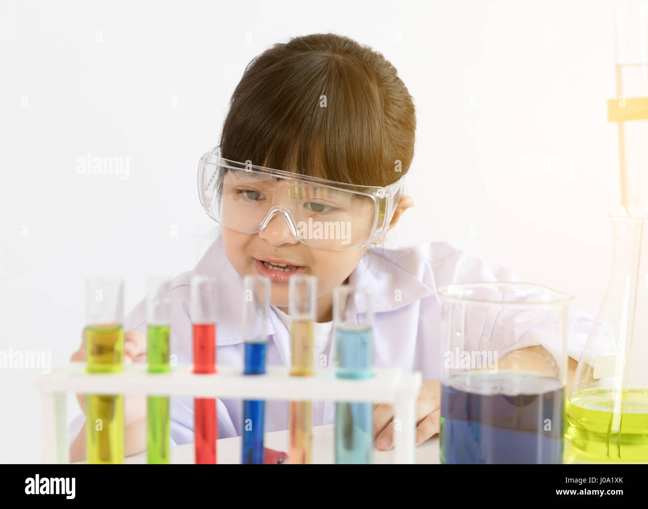 Asian child playing scientist with colorful lab tubes Stock Photo - Alamy