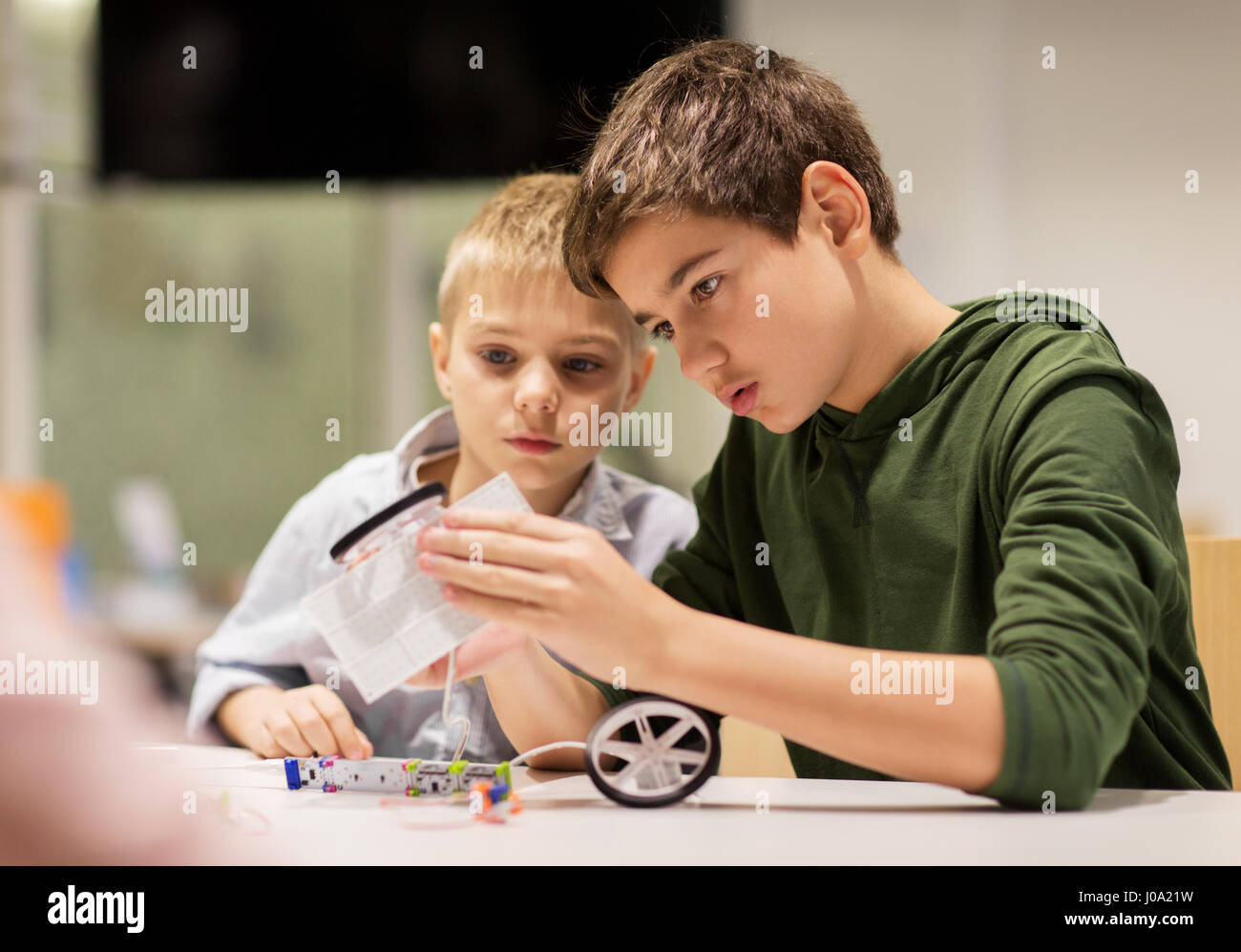 happy children building robots at robotics school Stock Photo - Alamy