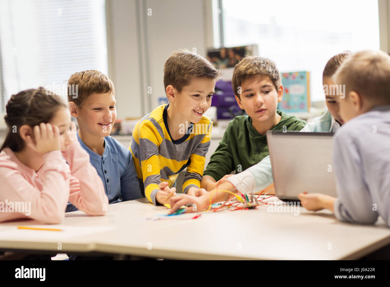 happy children with laptop at robotics school Stock Photo - Alamy