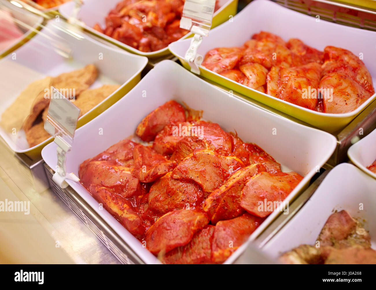 marinated meat in bowls at grocery stall Stock Photo - Alamy