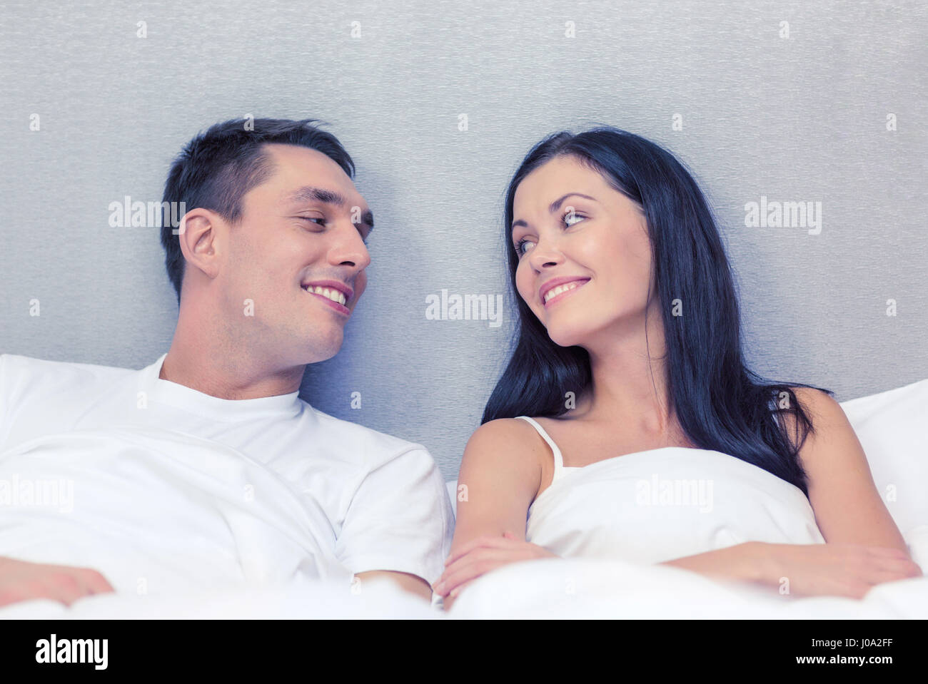 happy couple sleeping in bed Stock Photo - Alamy
