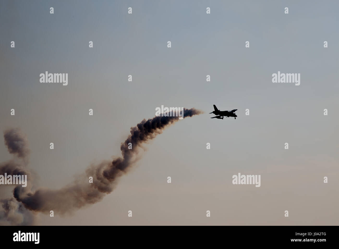 Plane with white smoke trail hi-res stock photography and images - Alamy