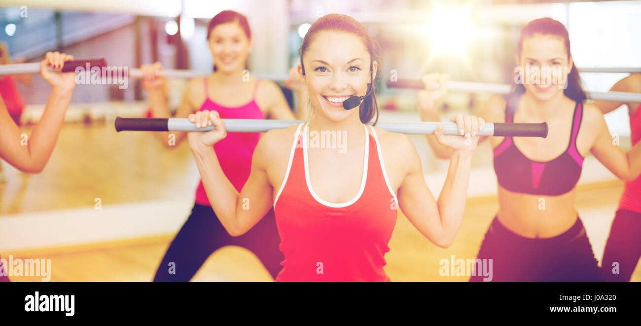 group of smiling people working out with barbells Stock Photo - Alamy