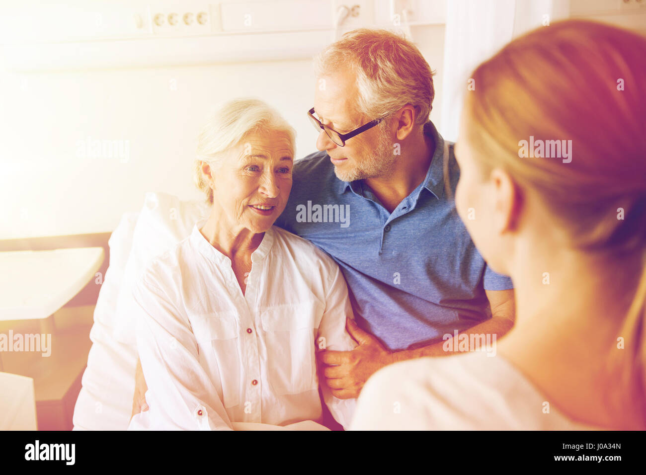 happy family visiting senior woman at hospital Stock Photo - Alamy