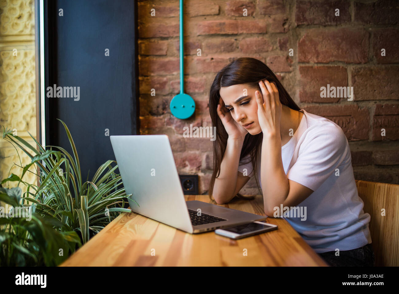 Shocked woman holding computer, laptop tablet screen looking surprised ...