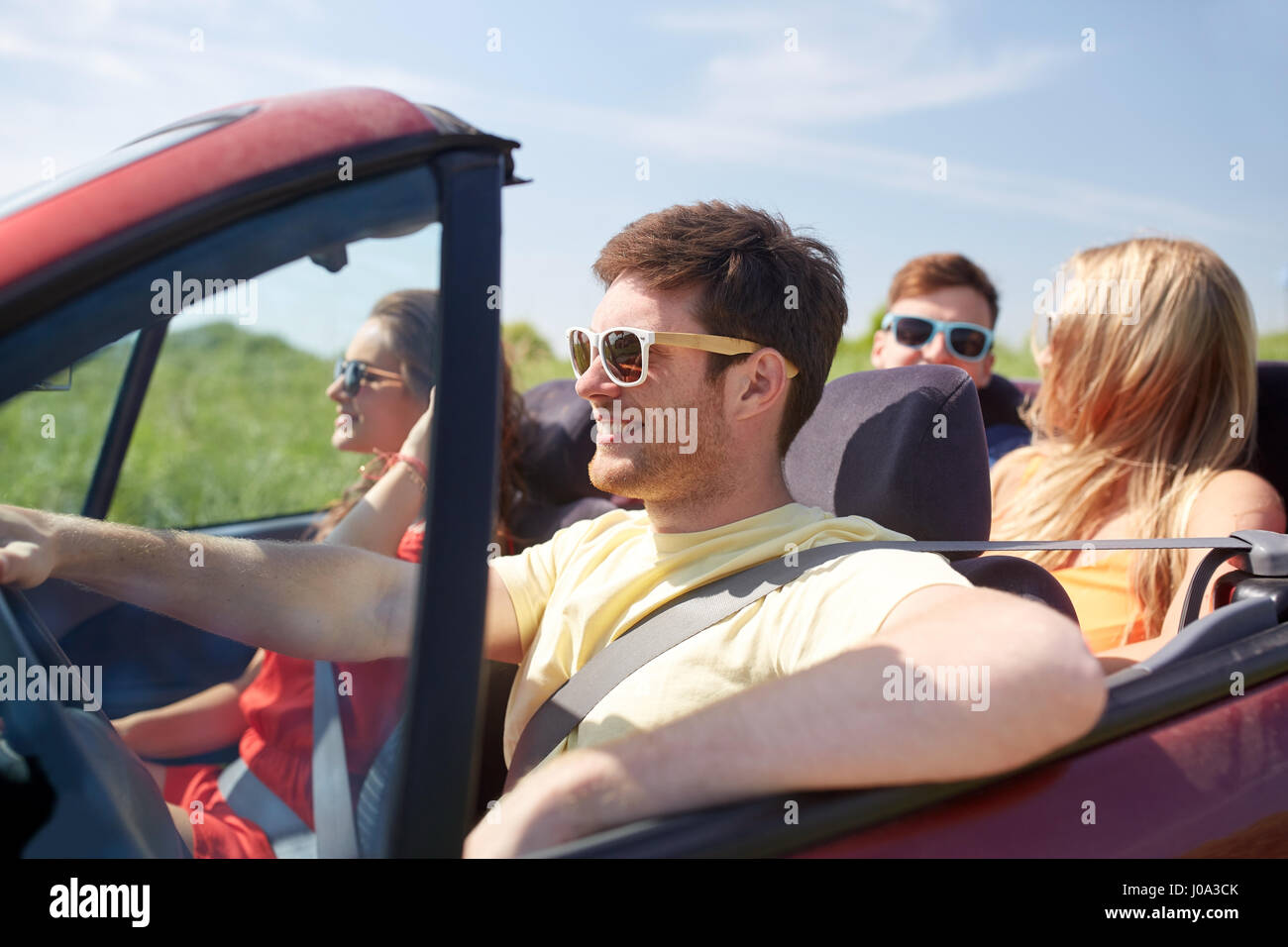 happy friends driving in cabriolet car Stock Photo - Alamy