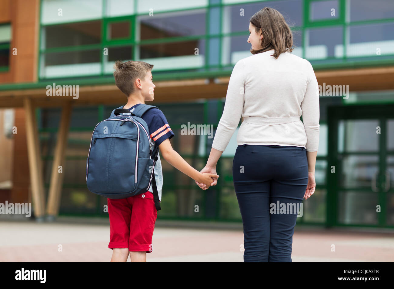 elementary student boy with mother at school yard Stock Photo - Alamy