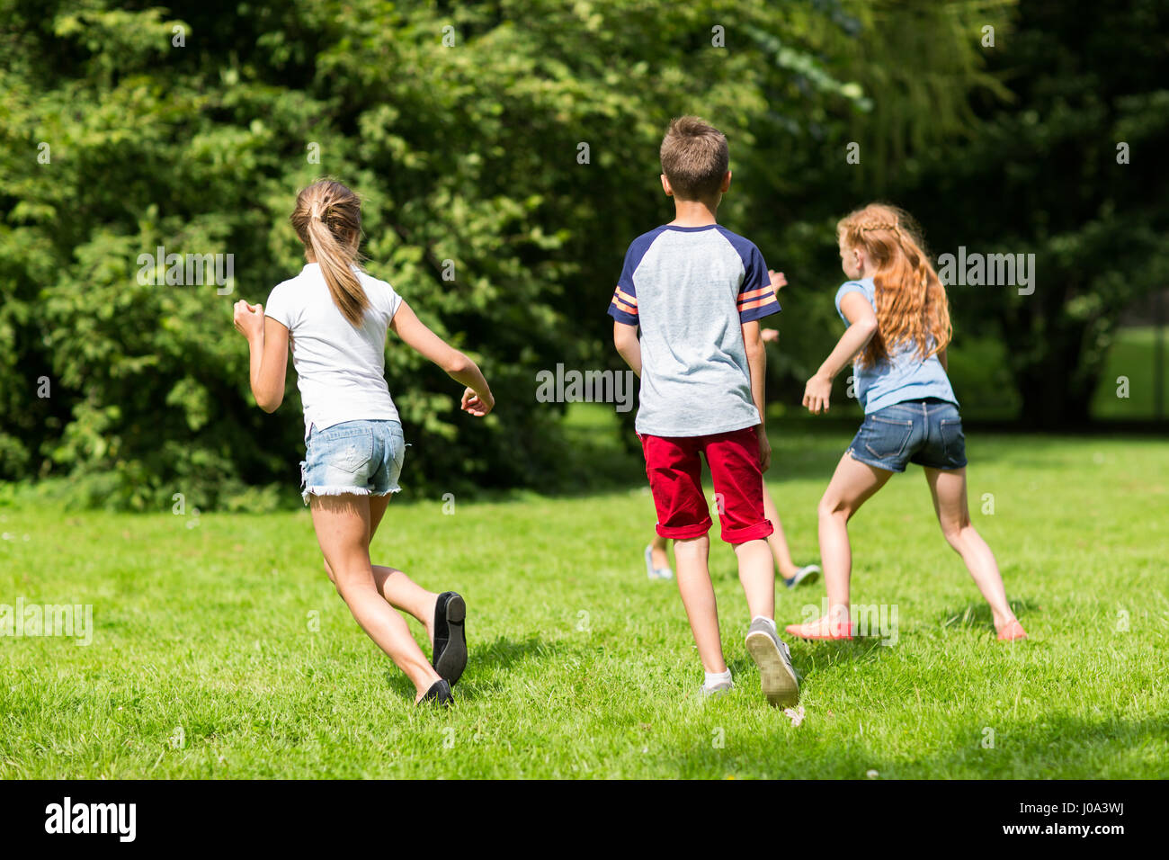 group of happy kids or friends playing outdoors Stock Photo - Alamy