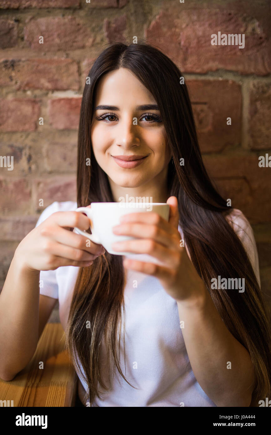 Portrait of young gorgeous female drinking tea of the coffee shop Stock ...