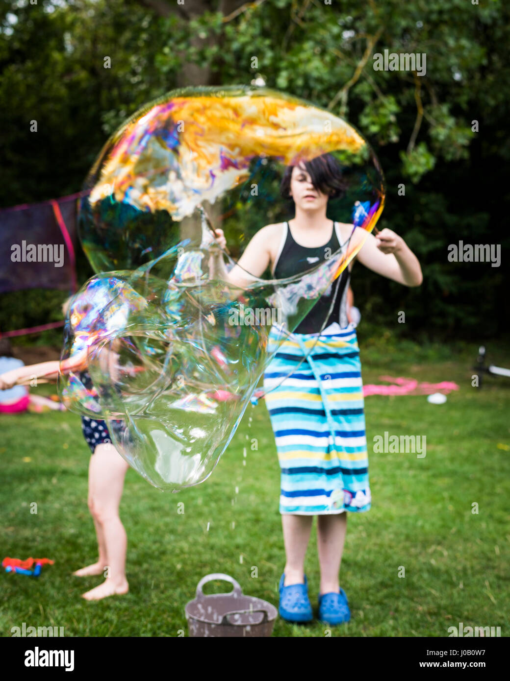 Children making giant bubbles at a festival Stock Photo - Alamy