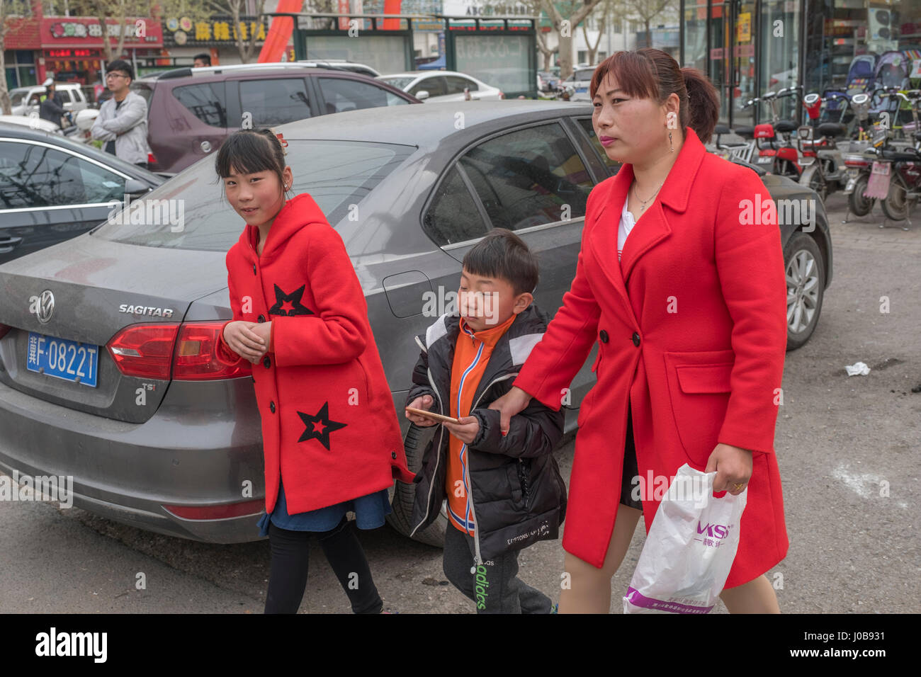 A mother with two children, one girl and one boy, in Xiong County ...