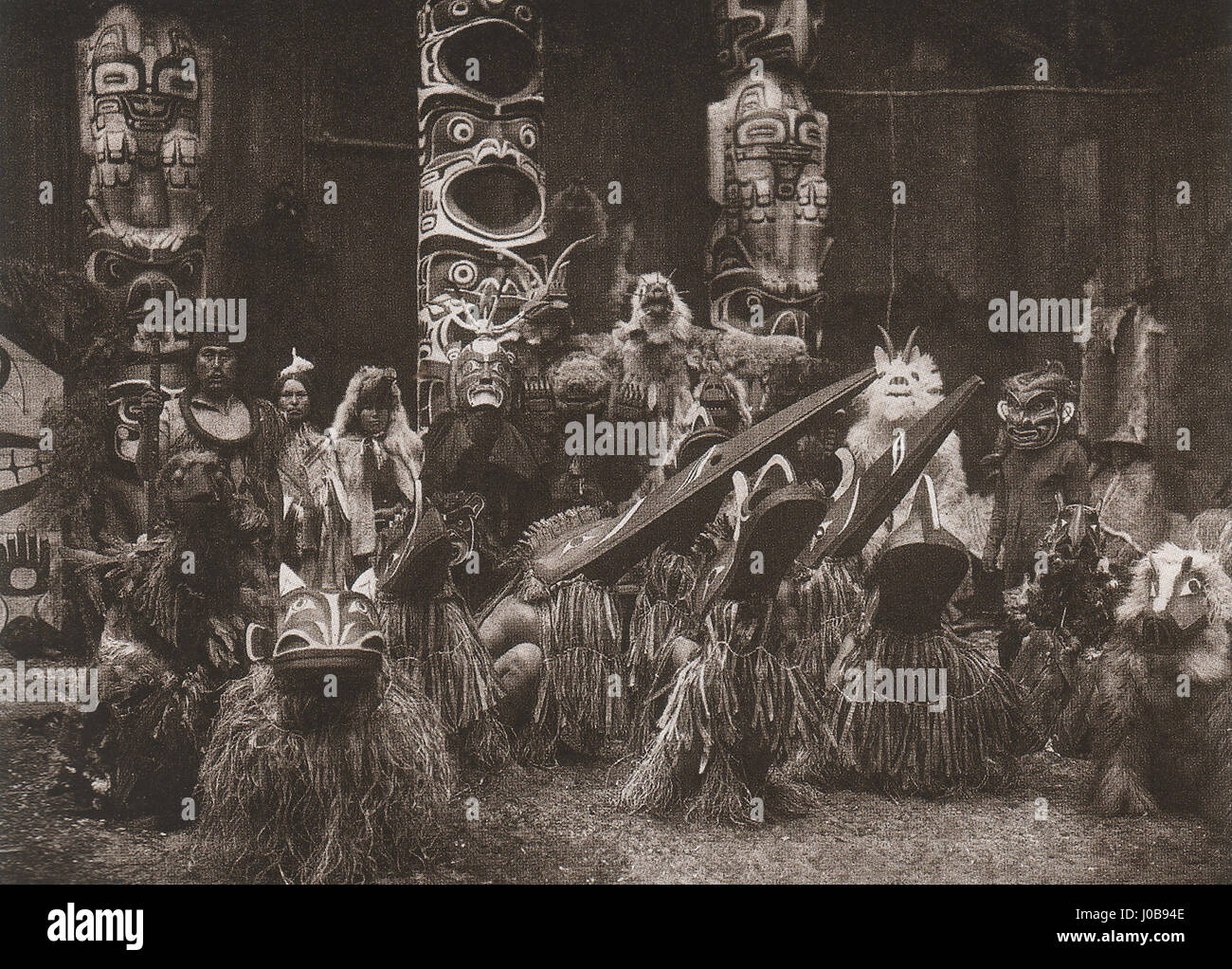 Masked dancers, Qágyuhl, Edward S. Curtis, 1914 Stock Photo - Alamy
